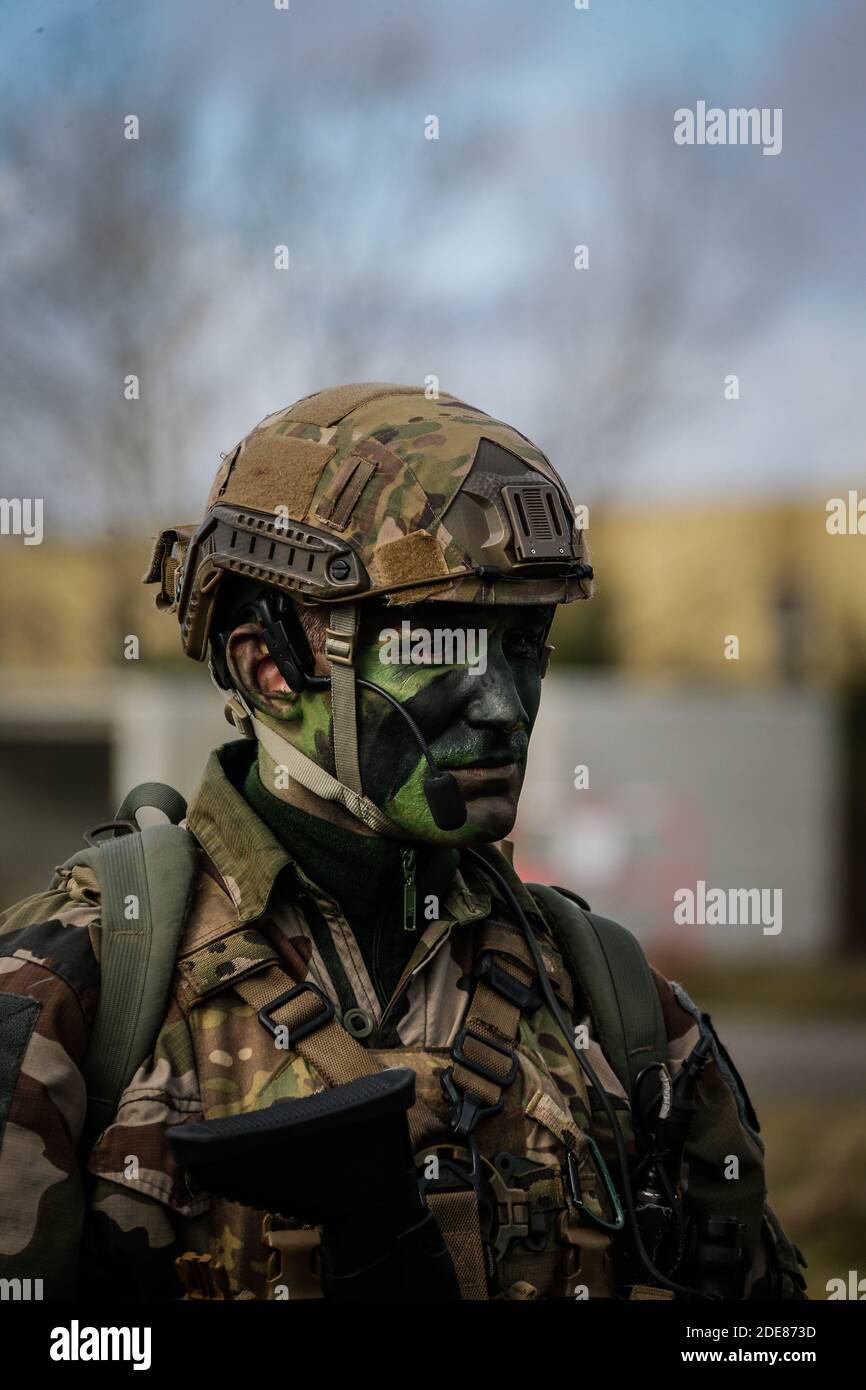 Members of a French parachute commando prepare for a military ceremony ...