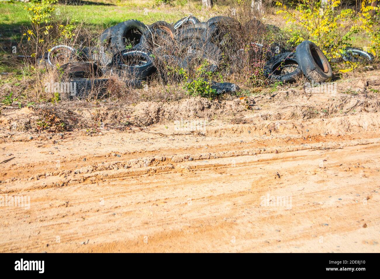A pile of old abandoned tires on the road side Stock Photo - Alamy