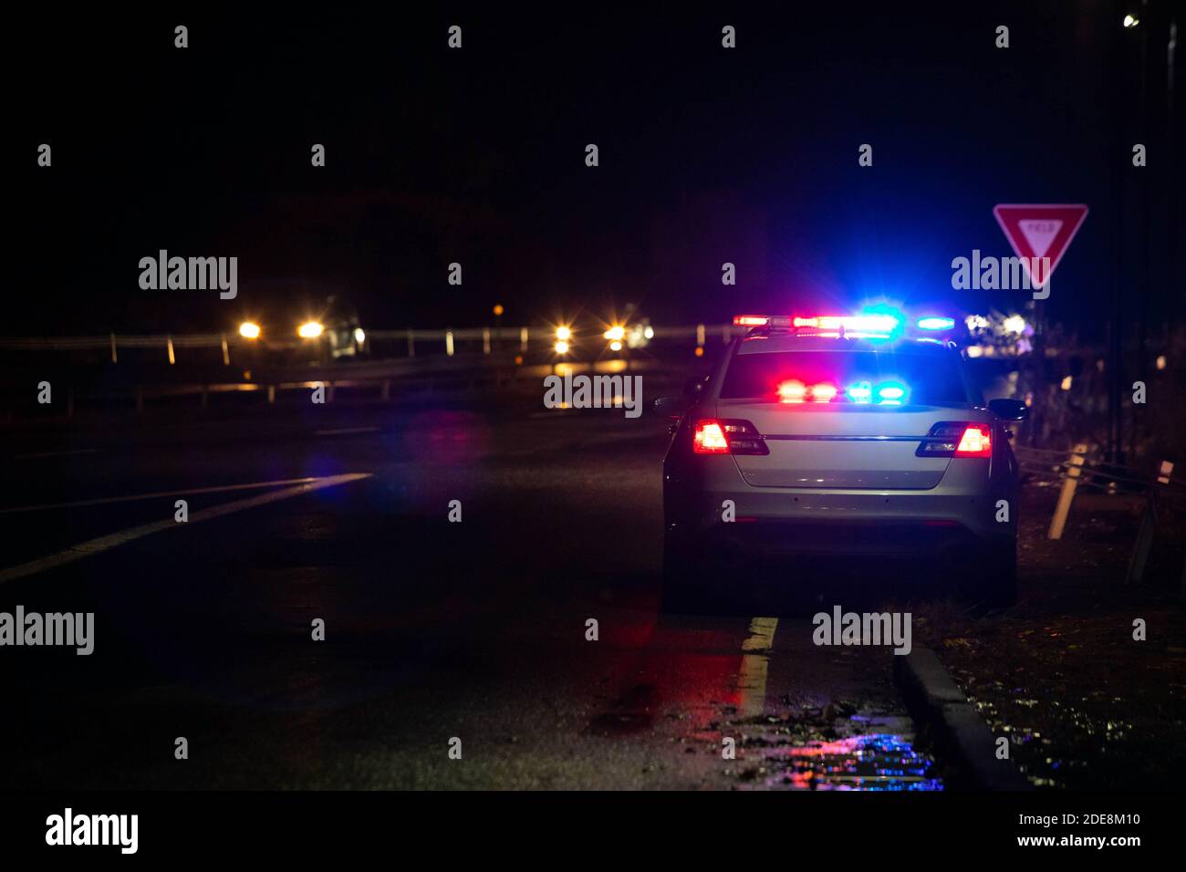Police emergency flash lights at night from the back on highway road ...