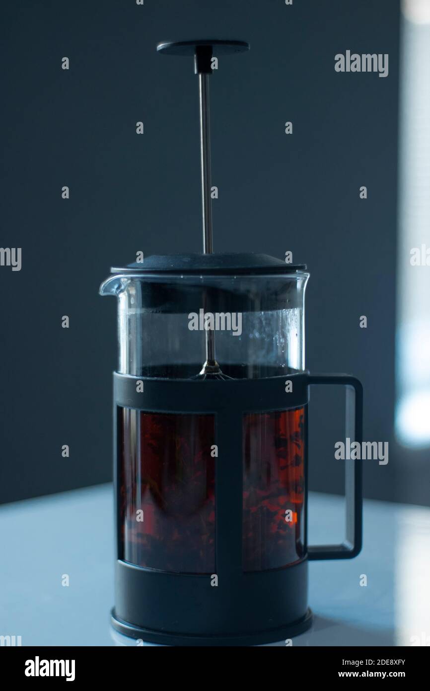 french press tea on a white table and grey background - vertical photo ...