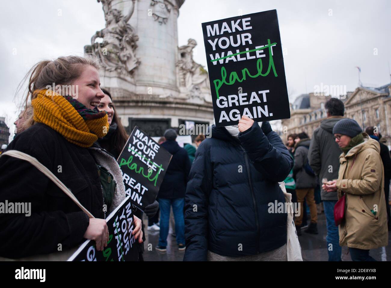 Women carry signs during a gathering for climate in Paris, France, on ...