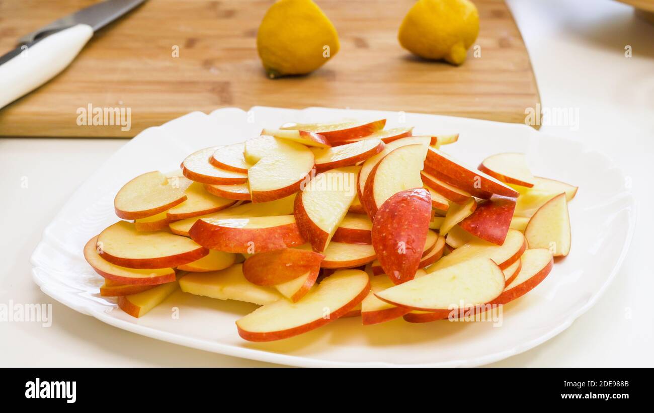 Apple slices close up on a plate on white background Stock Photo - Alamy