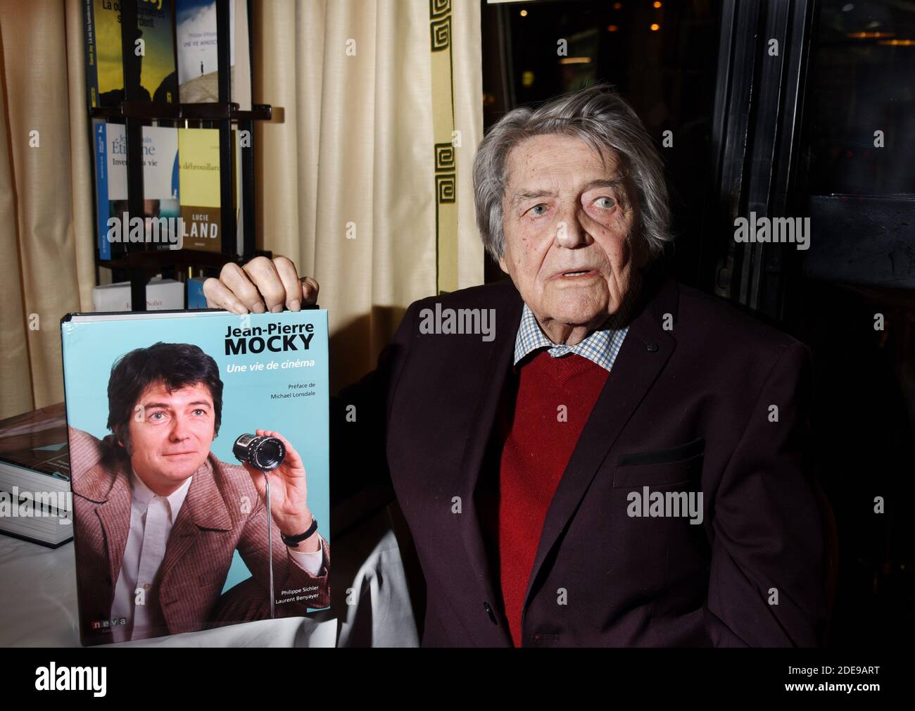 Actor and director Jean-Pierre Mocky signs his book Une Vie De Cinema ...