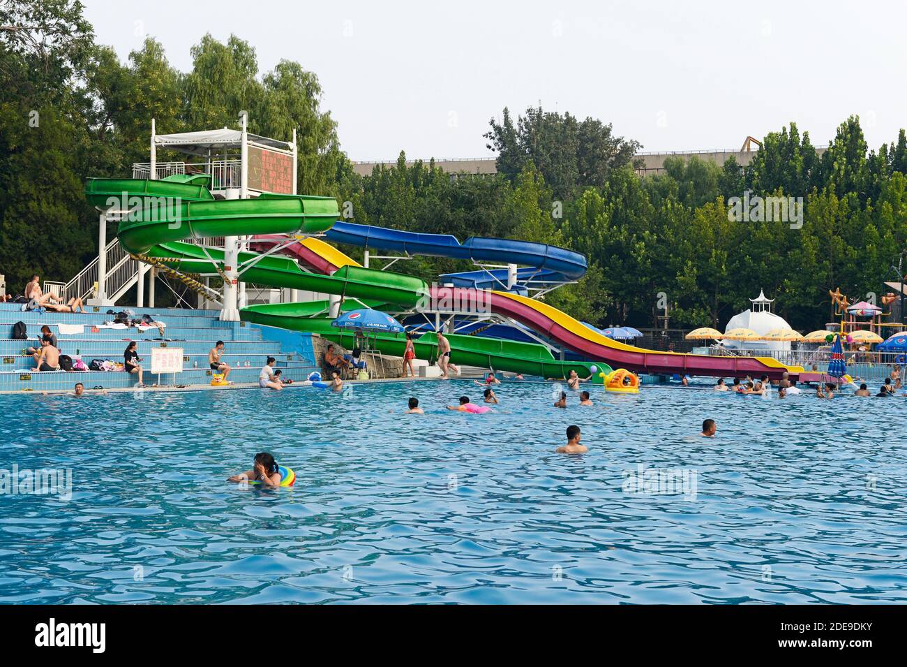 Many people enjoy using the swimming pool with its multi-coloured slide ...
