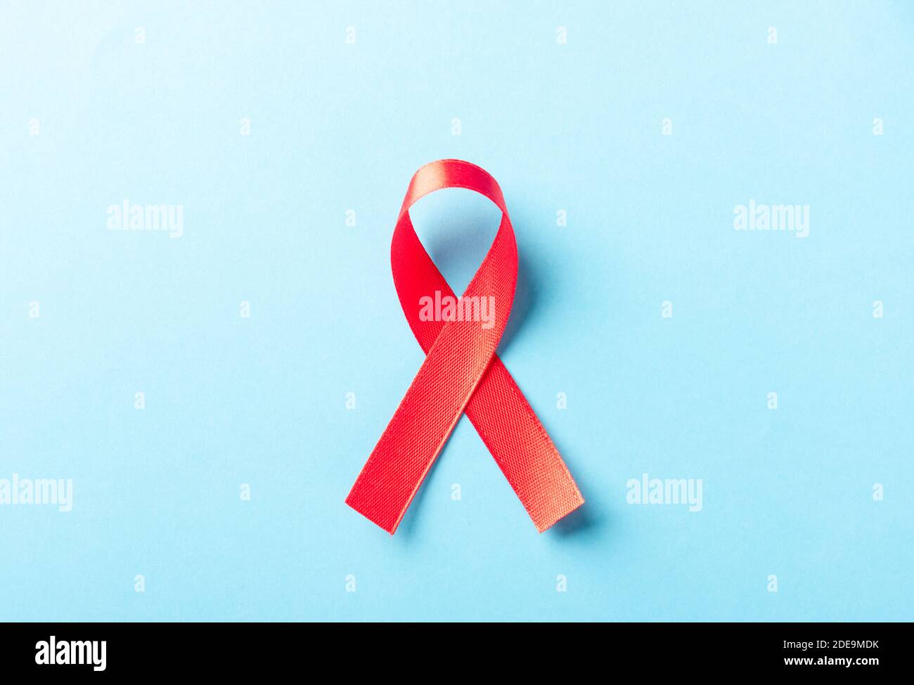 Red bow ribbon symbol HIV, AIDS cancer awareness with shadows, studio ...