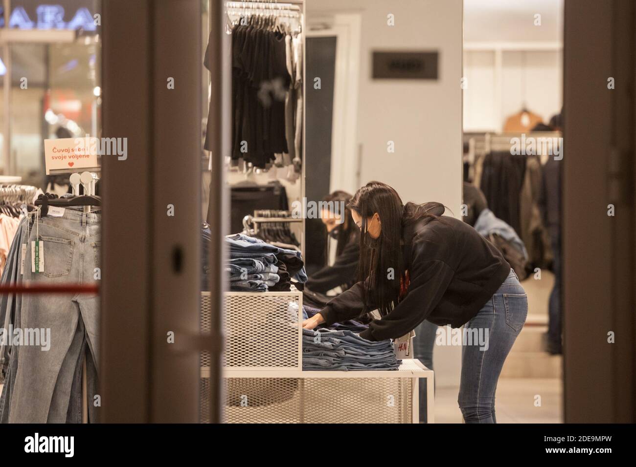Girl folding clothes in store hi-res stock photography and images - Alamy