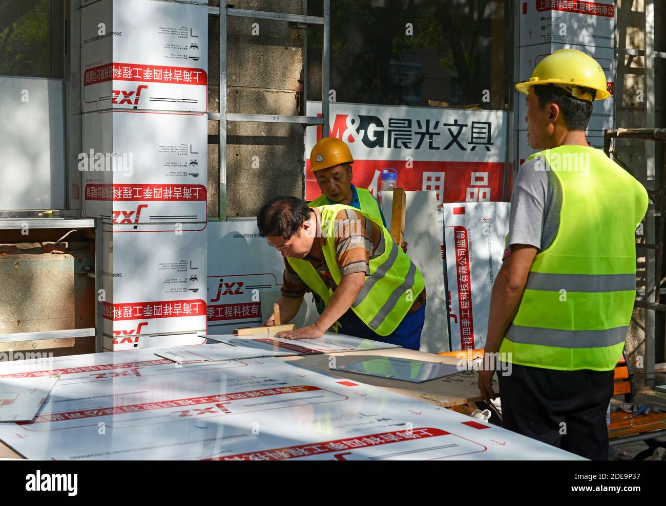 Workmen prepare a new shop frontage on a street in Beijing, China Stock ...