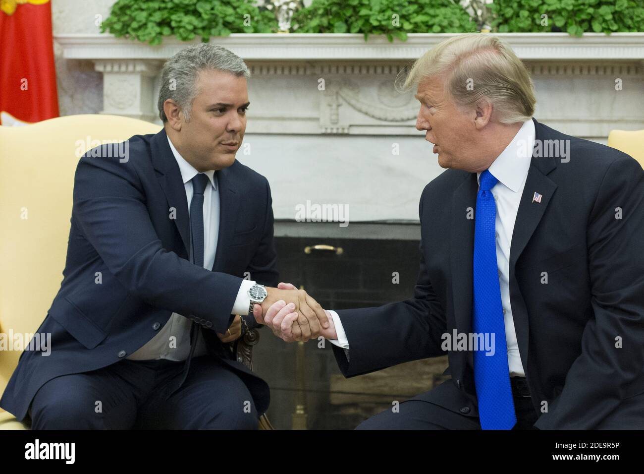 US President Donald J. Trump (R) shakes hands with the President of ...