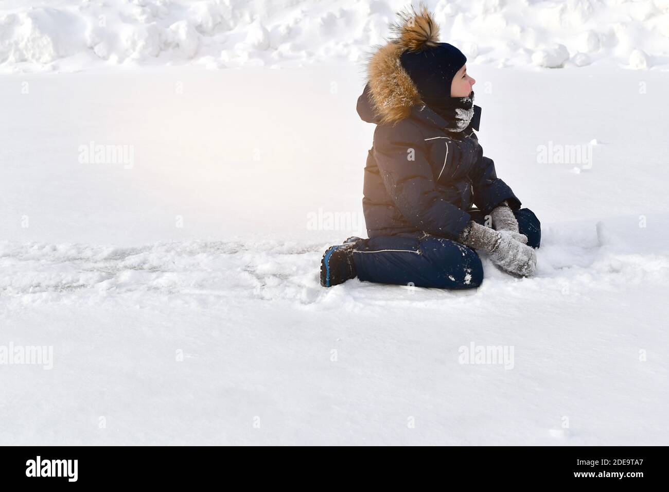 The child stopped at the end of his trail, sat down and stared into the ...