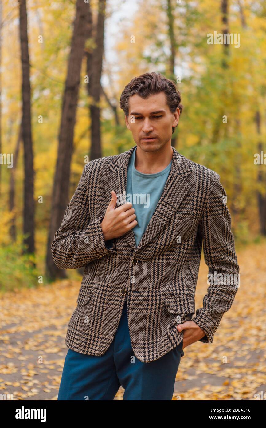 Tall handsome man on the autumn alley Stock Photo - Alamy