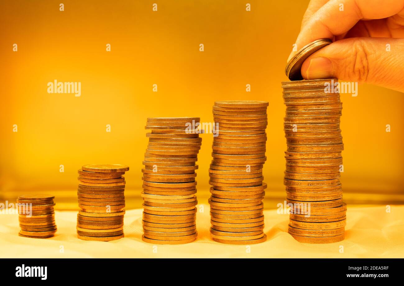 Increasing piles of gold coins with golden background. Concept for ...