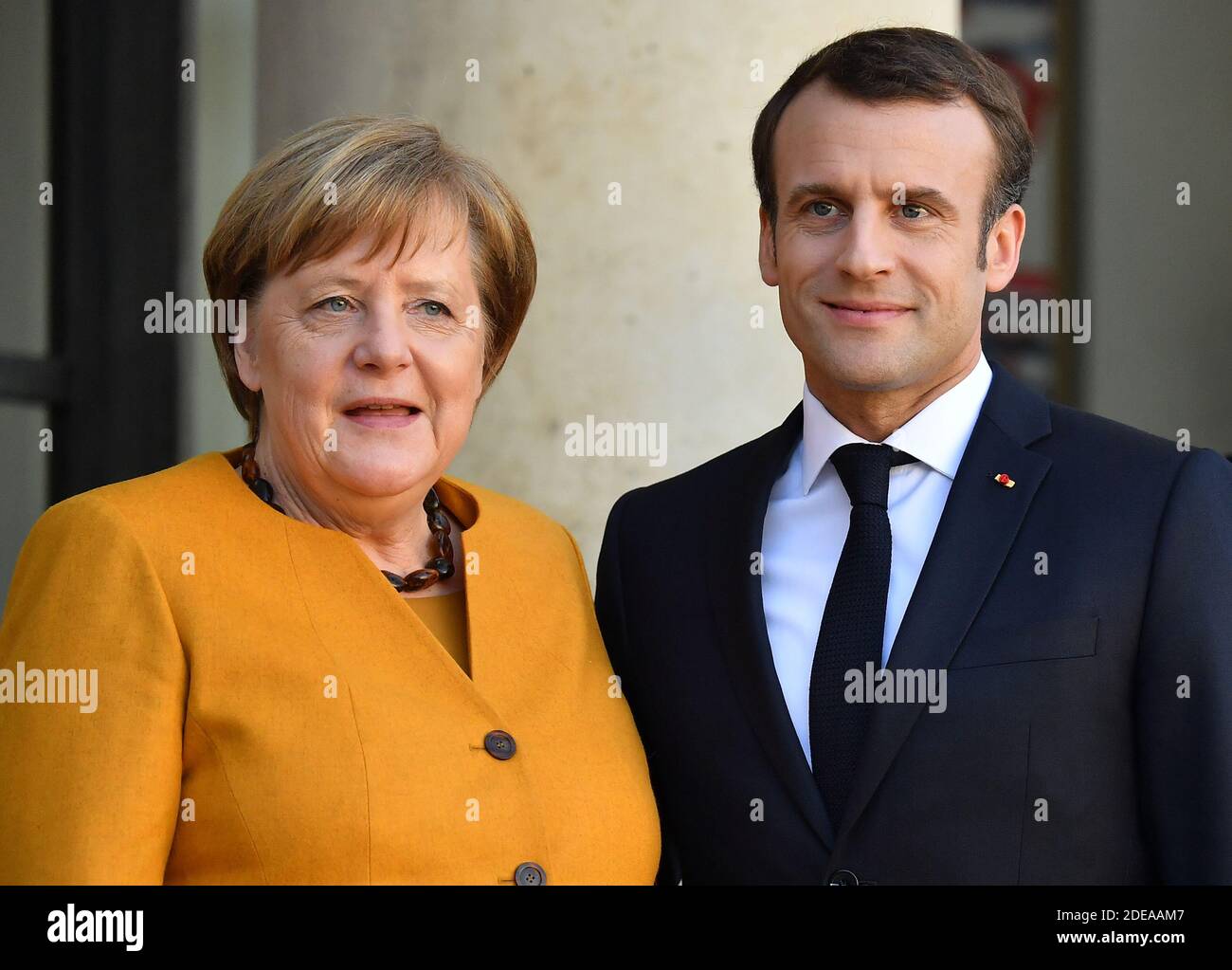 French President Emmanuel Macron greets German Chancellor Angela Merkel ...
