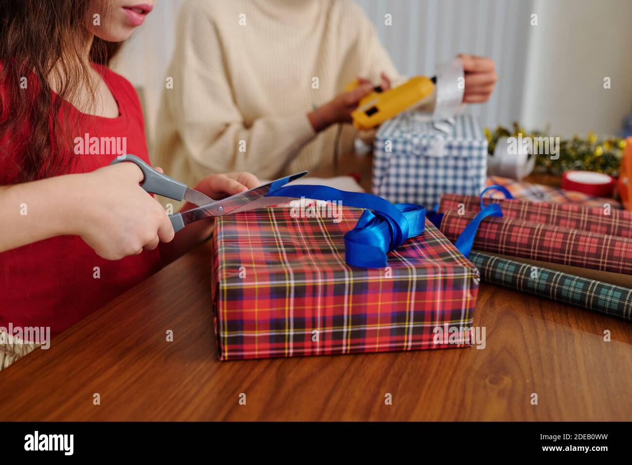 Girl wrapping presents Stock Photo - Alamy