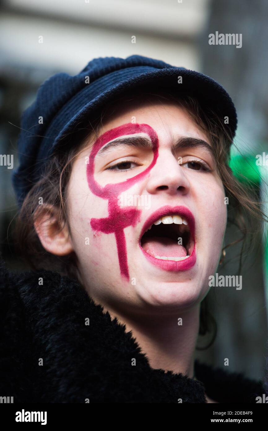 Women shout slogans with the women symbol on her face during the ...