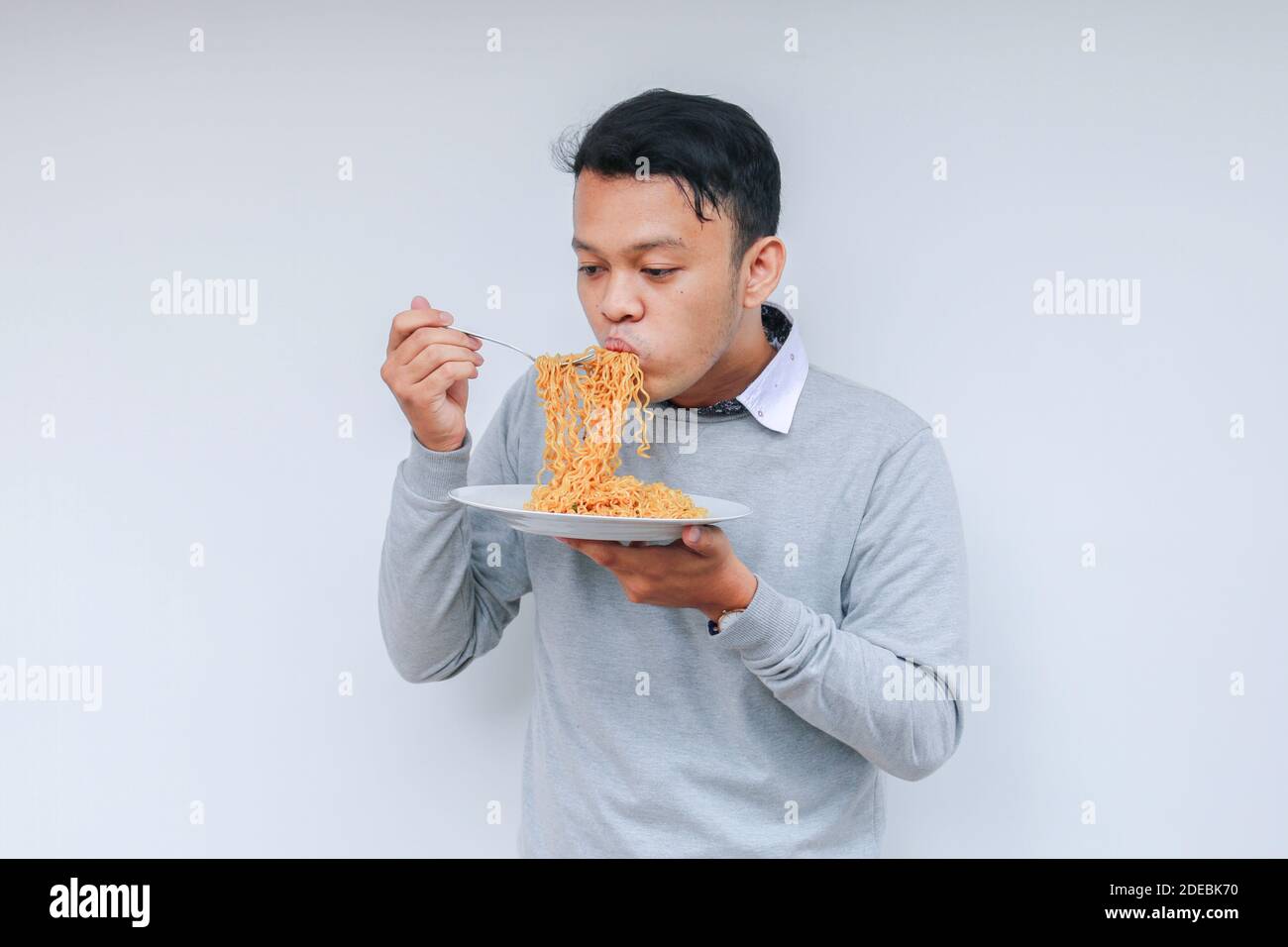 Young Asian man enjoy noodles. Eating lunch concept Stock Photo - Alamy