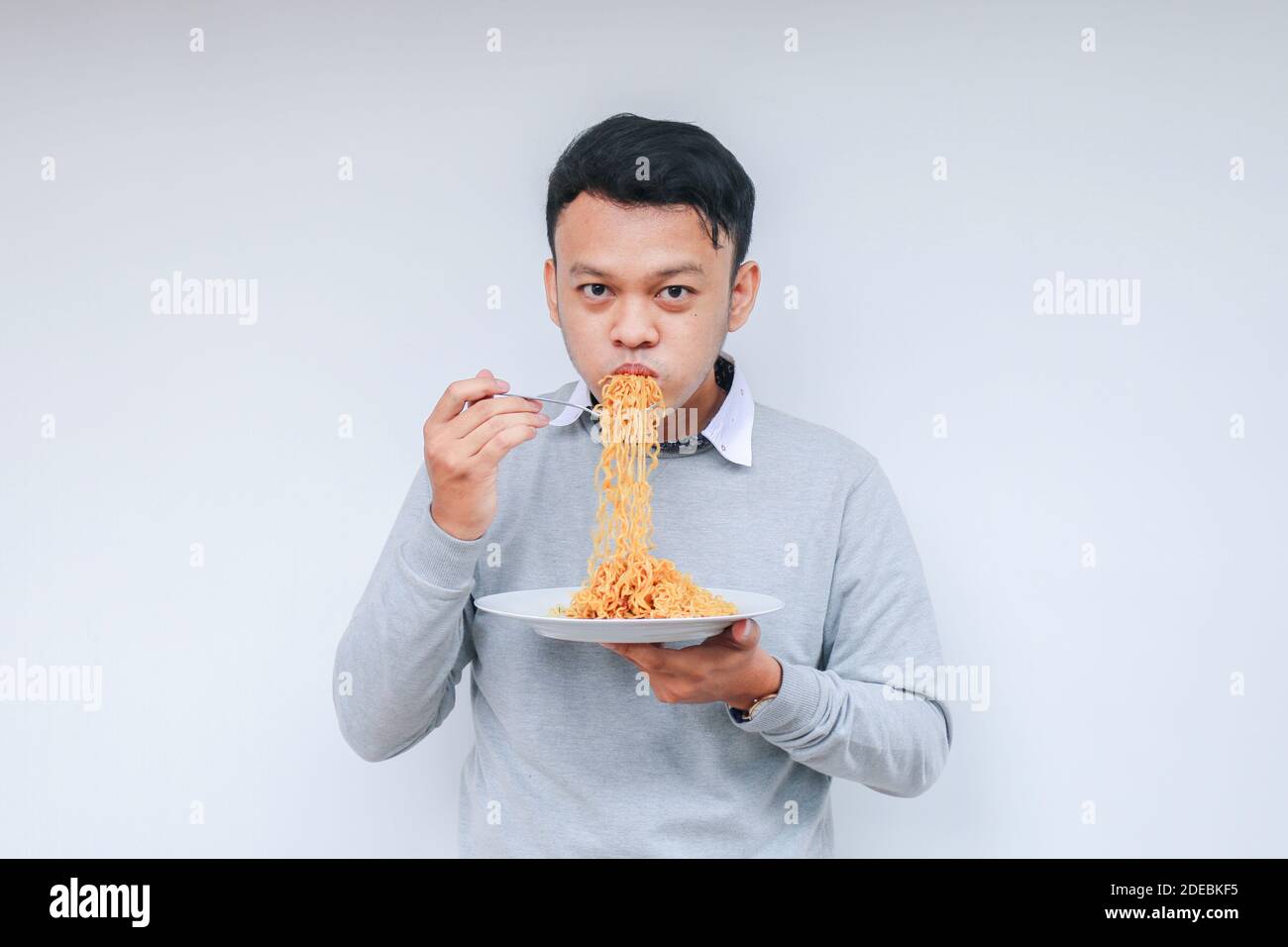 Young Asian man enjoy noodles. Eating lunch concept Stock Photo - Alamy