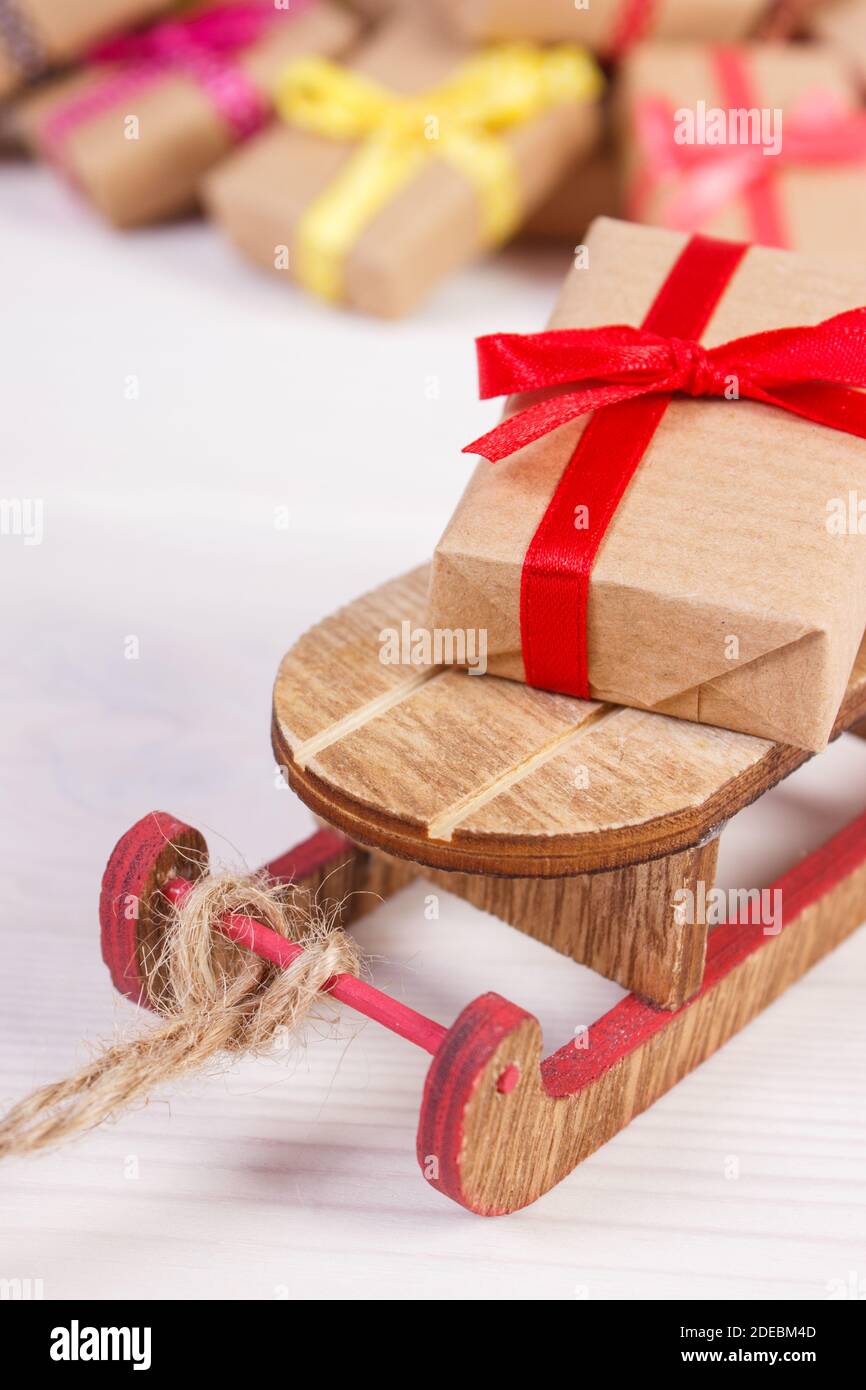 Wooden sled and wrapped gifts with colorful ribbons for Christmas ...
