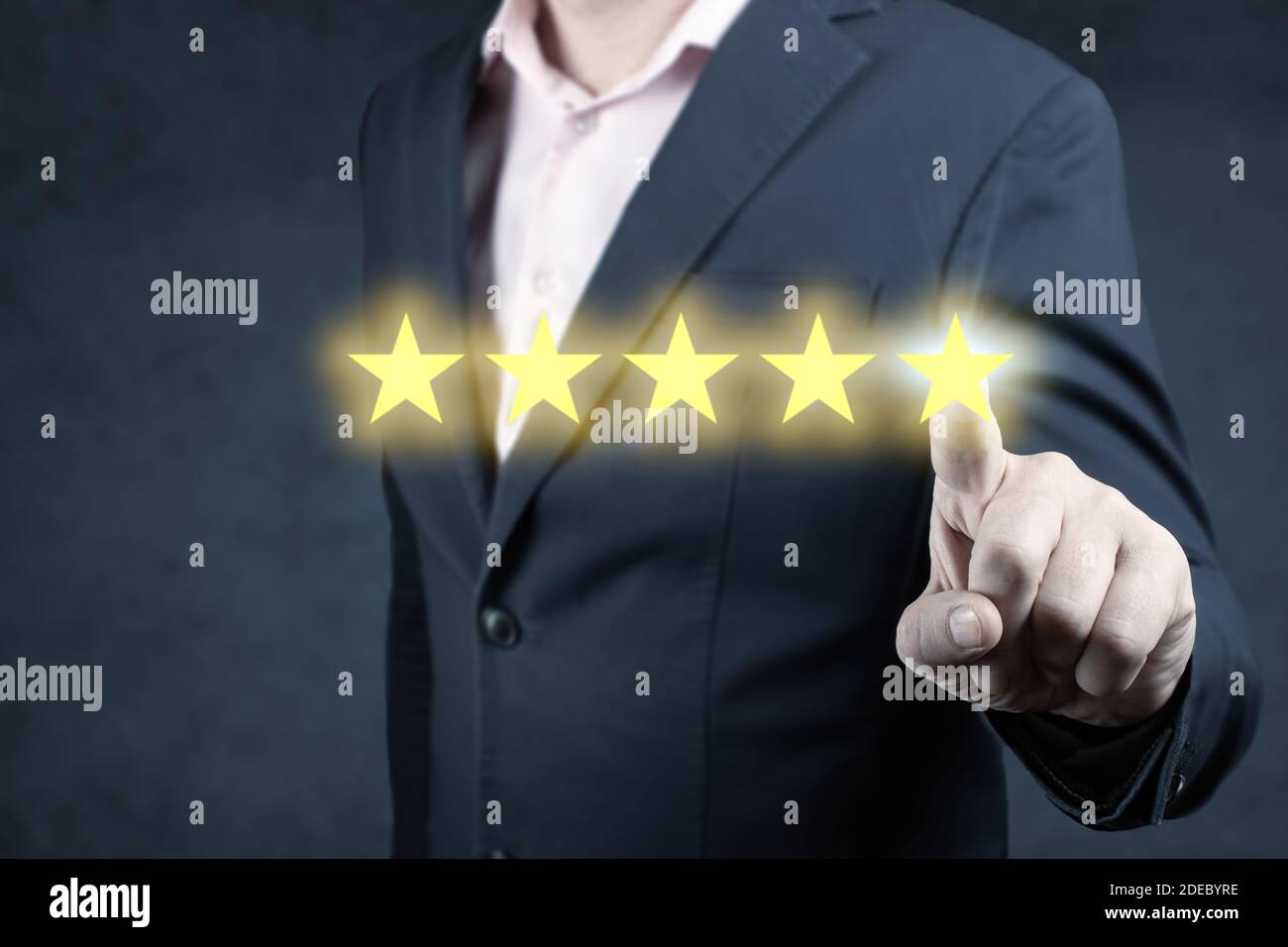 Businessman giving a five star rating. Businessman pointing five star ... Businessman giving a five star rating. Businessman pointing five star ...