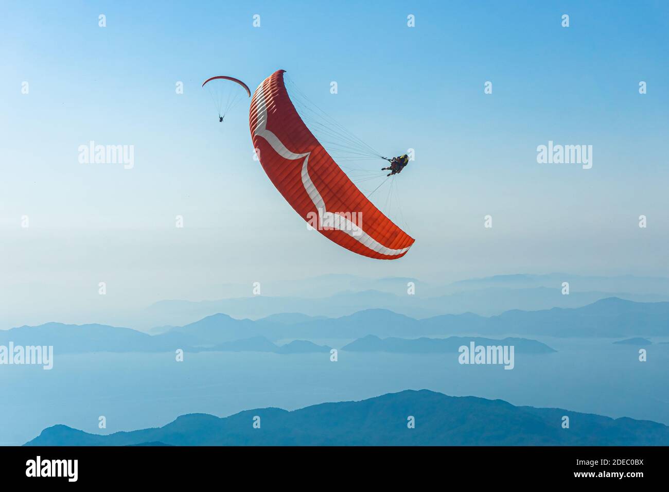 Paragliding in the sky. Paraglider tandem flying over the sea with ...
