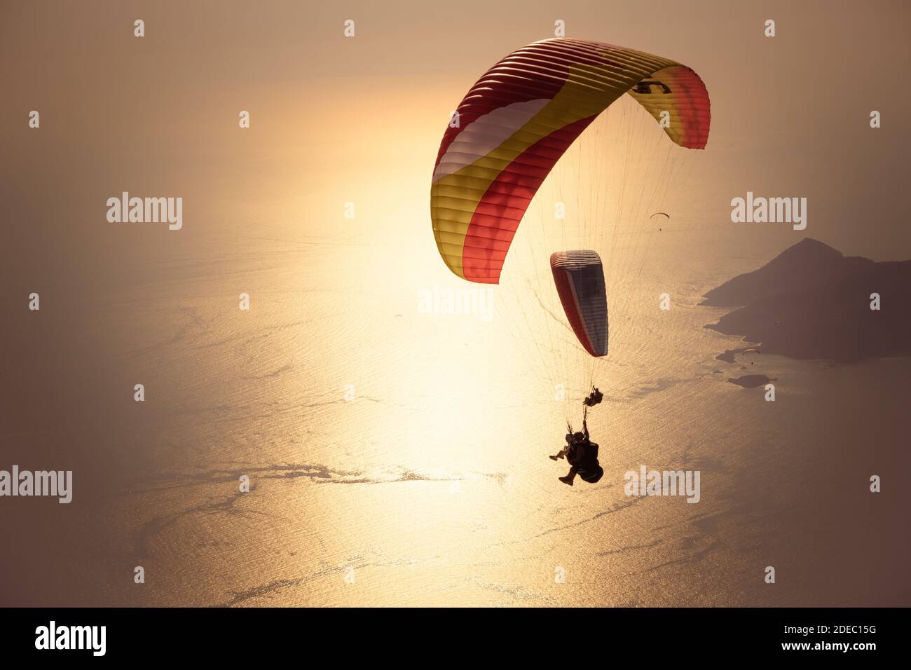Paragliding in the sky. Paraglider tandem flying over the sea with ...