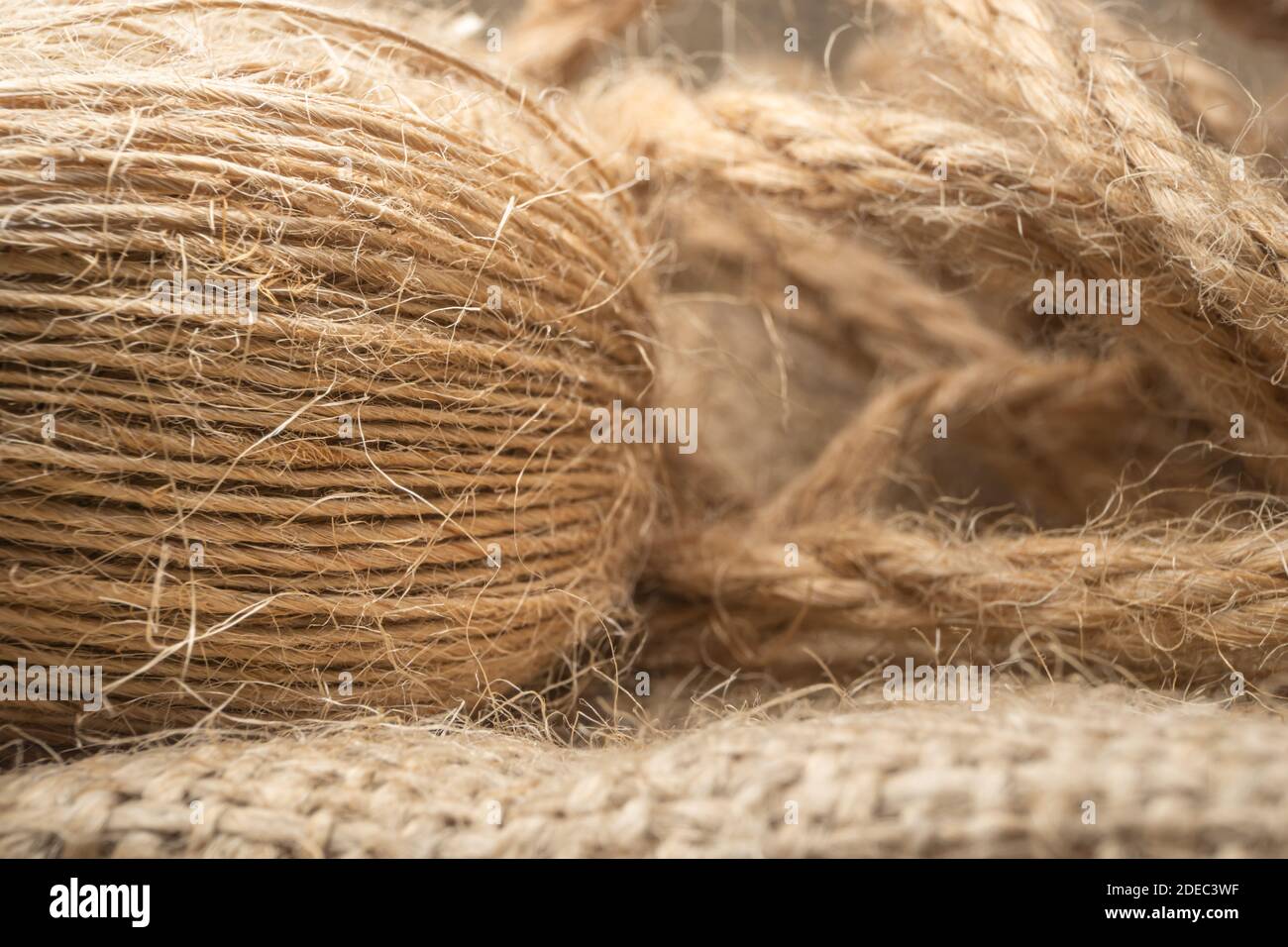 Macro view with natural jute twine roll isolated on natural linen ...