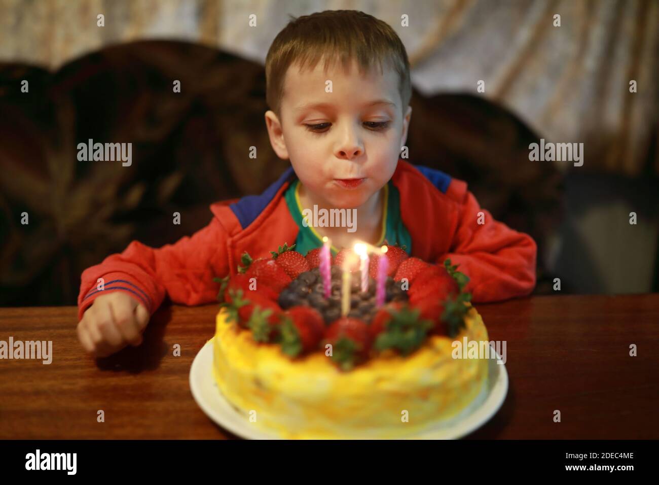 Cute kid blowing out hi-res stock photography and images - Alamy