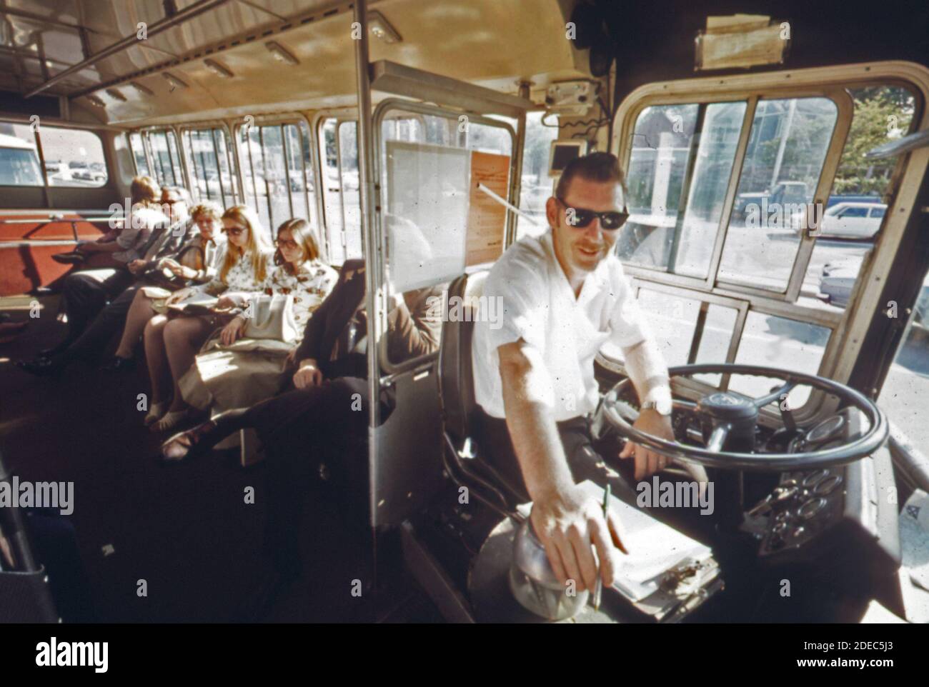 Bus driver and passengers on a dial a ride radio dispatched door-to ...