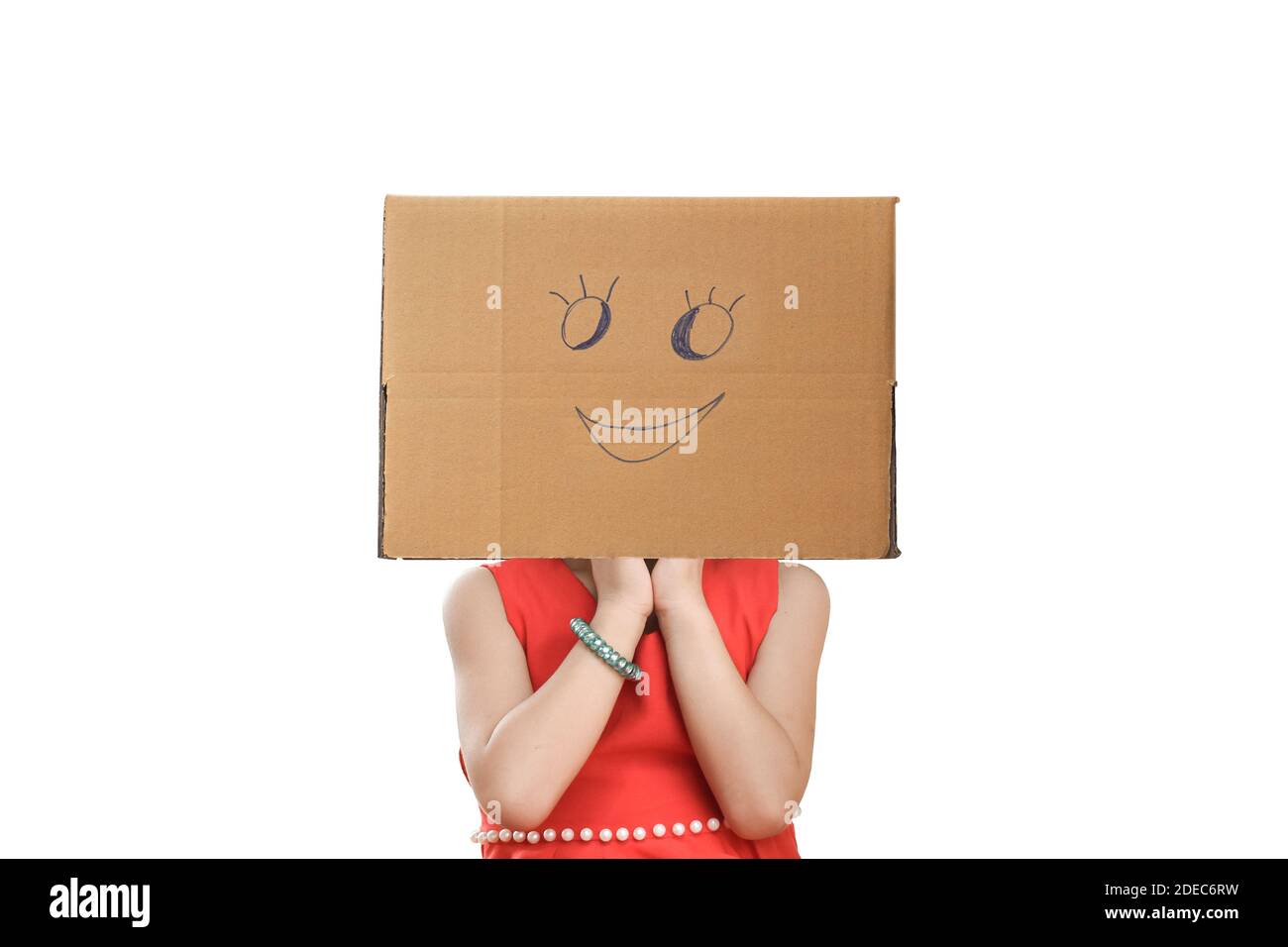Little girl wearing cardboard box on his head with smiley face ...
