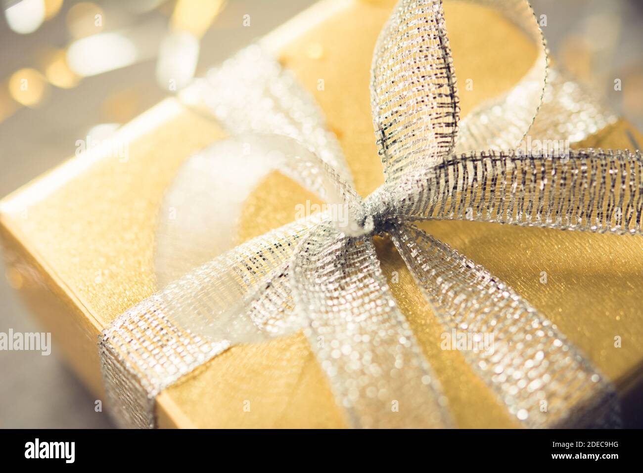 Close up of Christmas gift box with shiny glittering silver ribbon bow ...