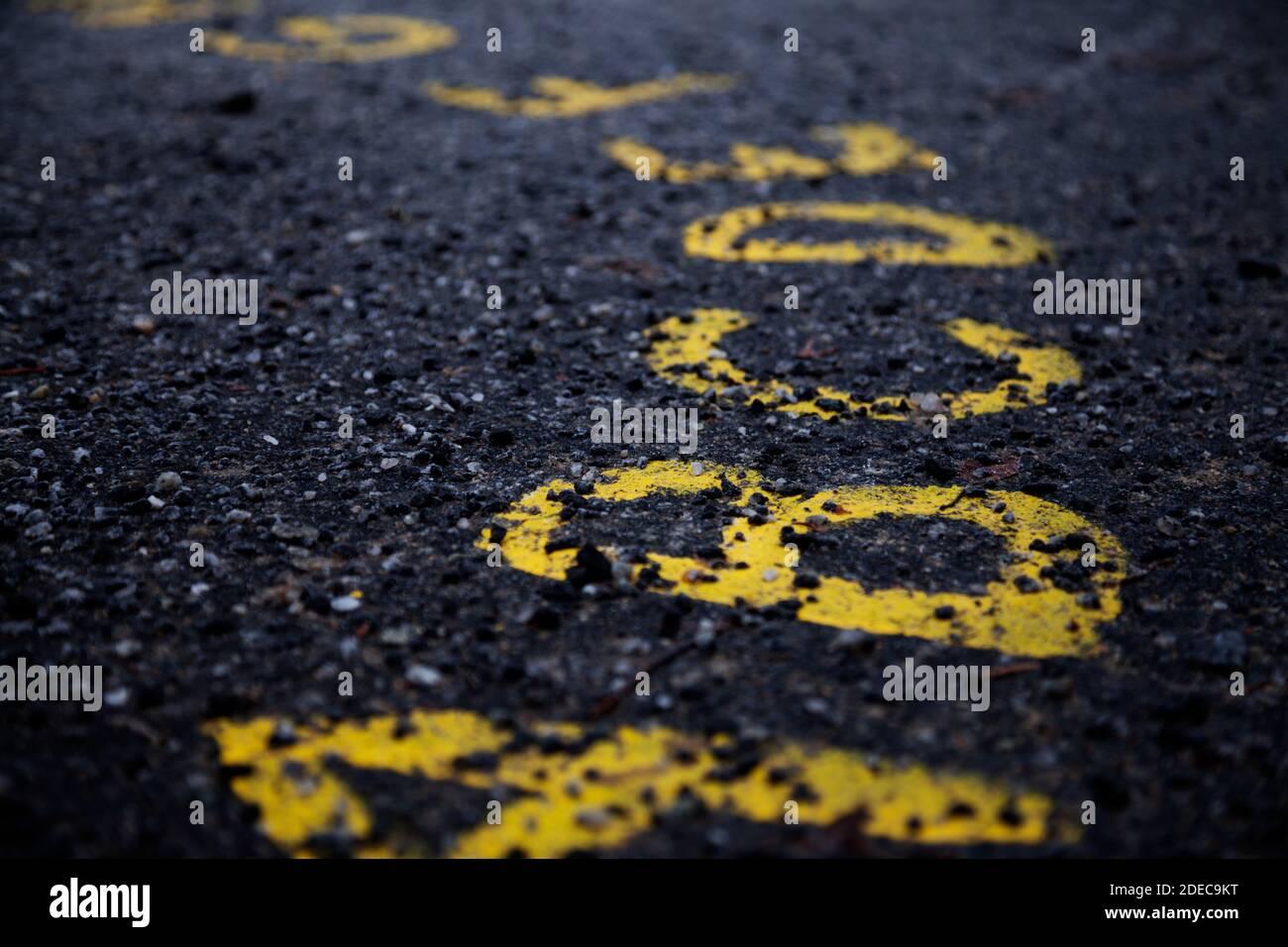 the alphabet written in yellow text on asphalt Stock Photo - Alamy