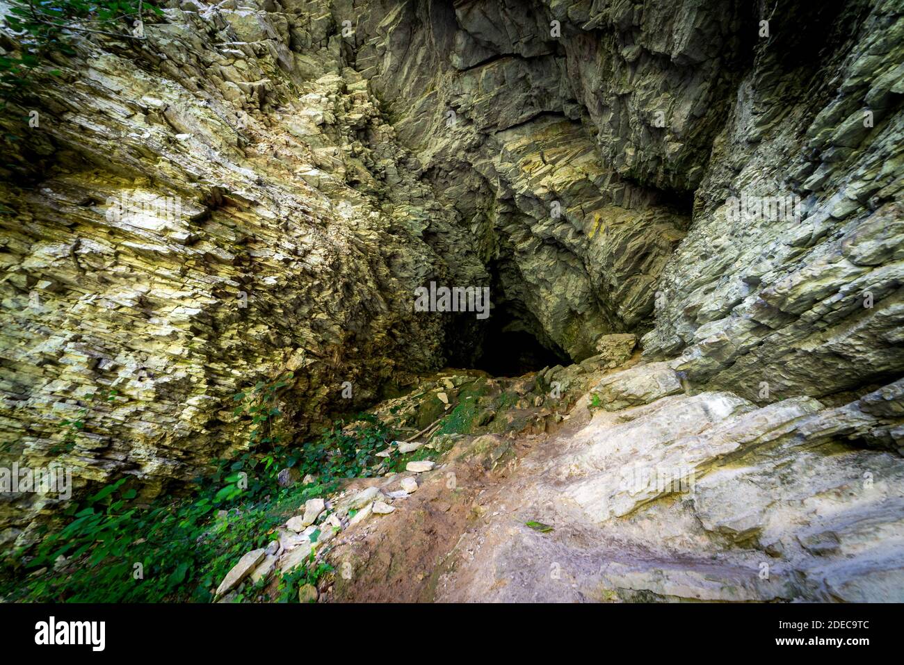 Entrance in dark cave in mountain area Stock Photo - Alamy