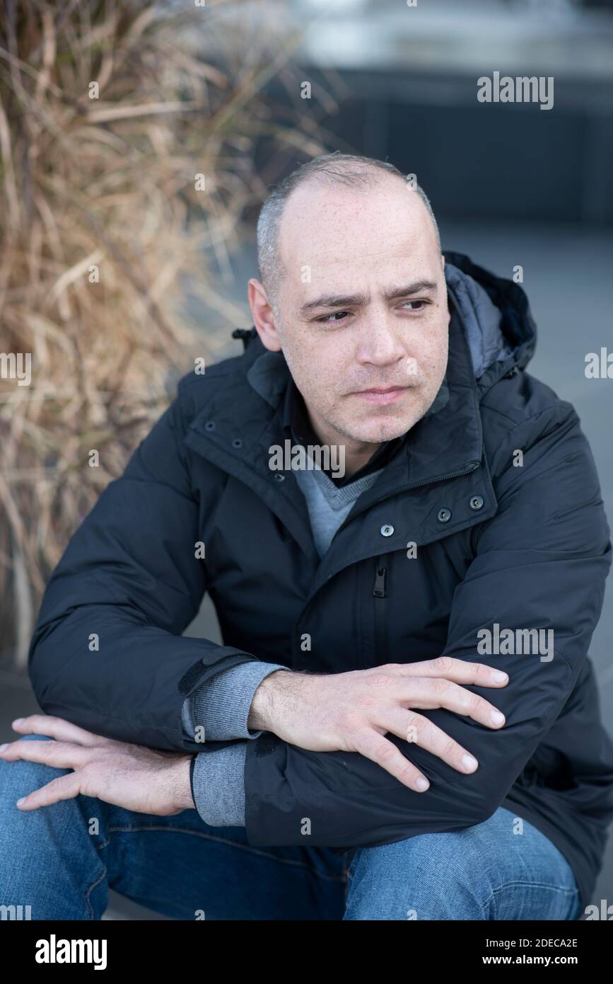 45 years old man sitting outdoors Stock Photo - Alamy