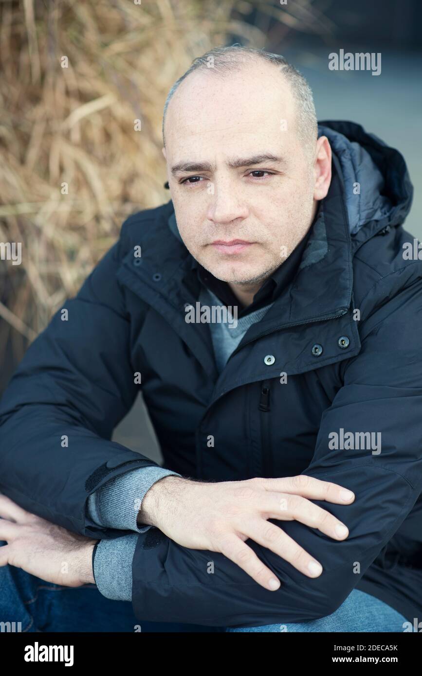 45 years old man sitting outdoors Stock Photo - Alamy
