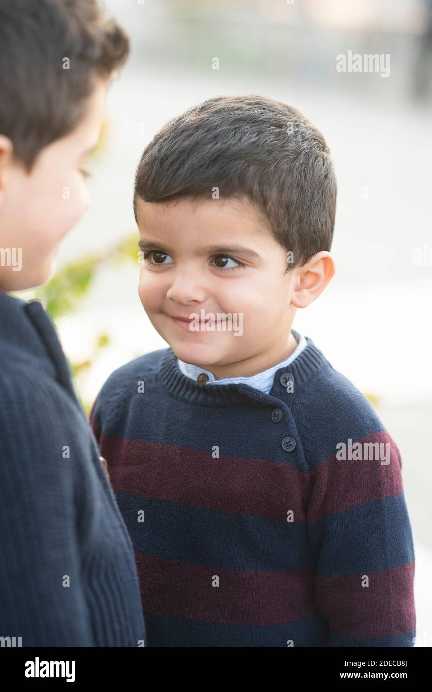 two boys looking at each others outdoors Stock Photo - Alamy