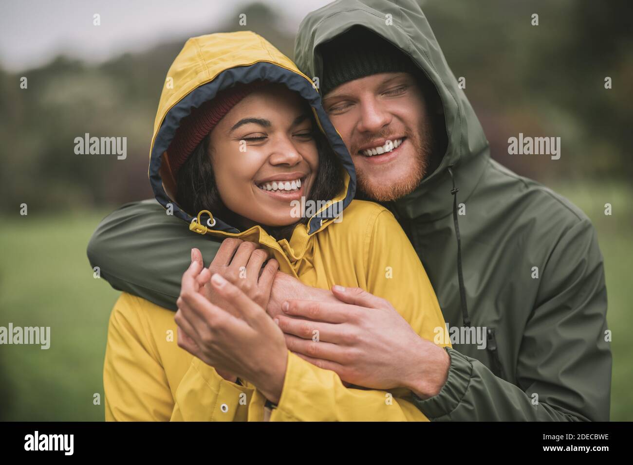 Interracial couple hugging outdoors hi-res stock photography and images ...