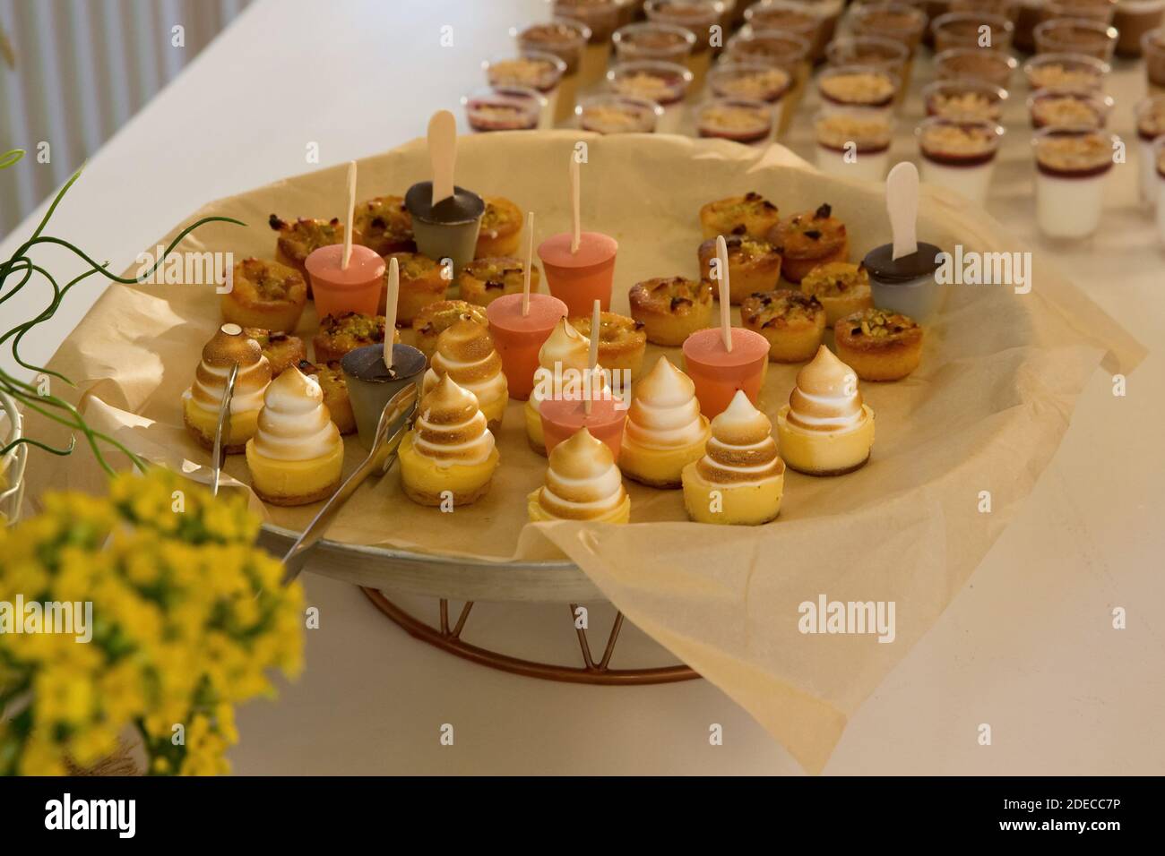 A buffet table laden with food. A dessert plate of sweet tartelettes ...