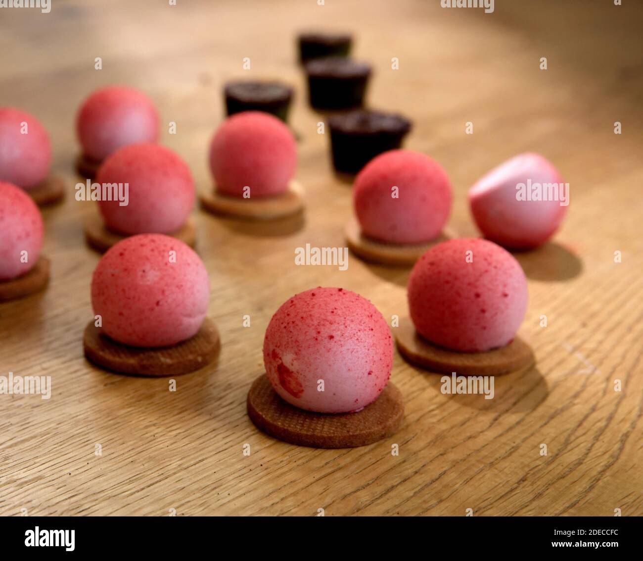 Puffs. Balls of strawberry flavoured mousse on a biscuit base Stock ...