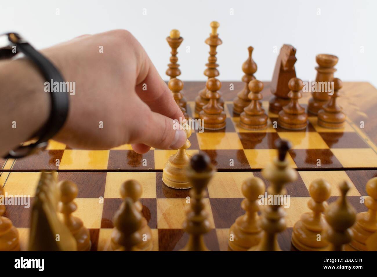 man takes a step with a chess piece Stock Photo - Alamy