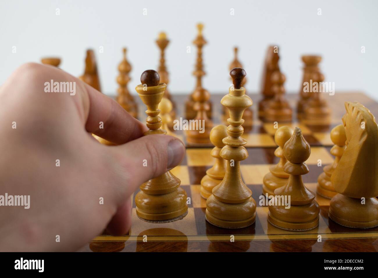 man takes a step with a chess piece Stock Photo - Alamy
