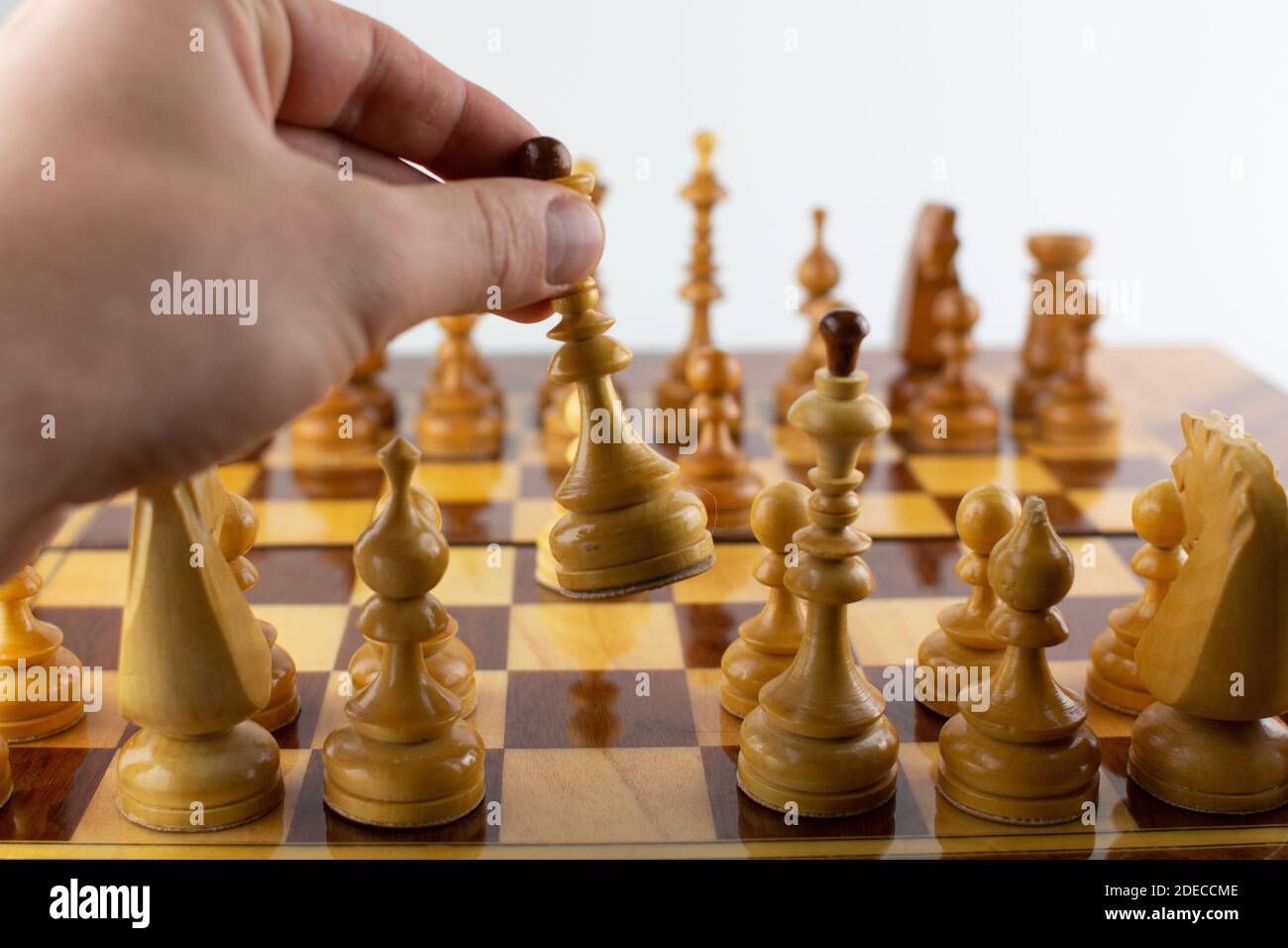 man takes a step with a chess piece Stock Photo - Alamy