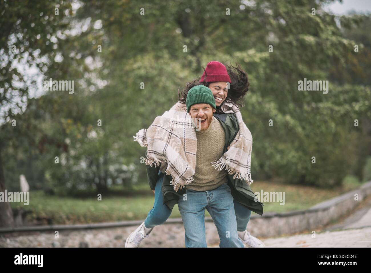 Man carrying a woman on his back Stock Photo - Alamy