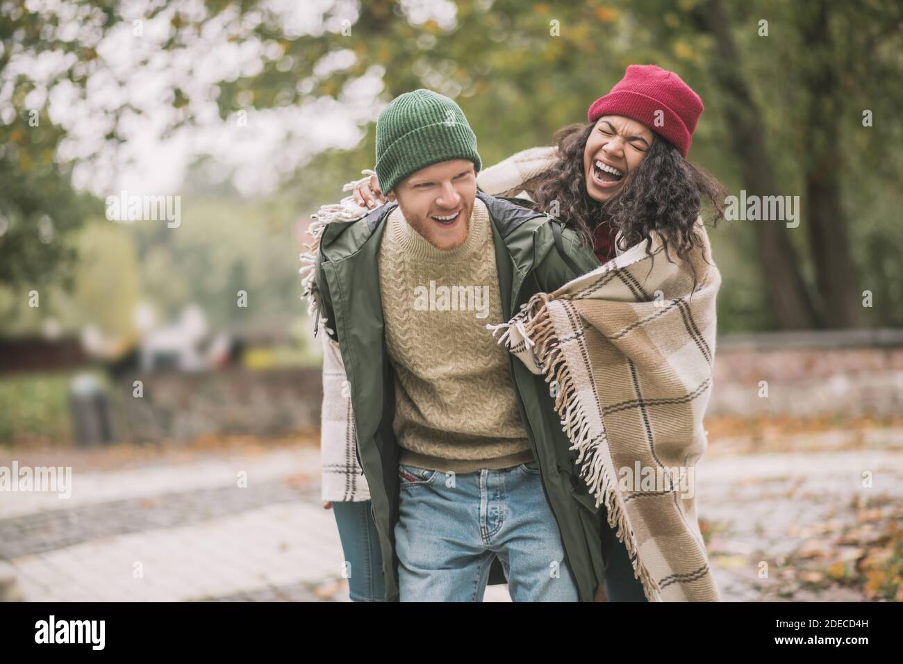 Man trying to put a woman on his back Stock Photo - Alamy