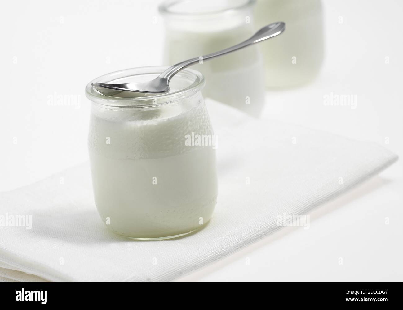 Glasses of Natural Yoghurt against White Background Stock Photo - Alamy
