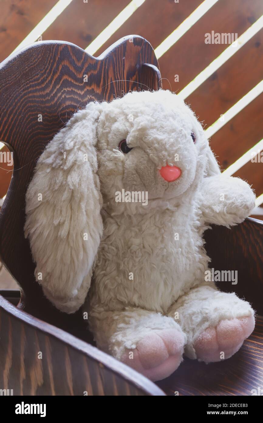 White stuffed rabbit sitting in a brown rocking chair Stock Photo - Alamy
