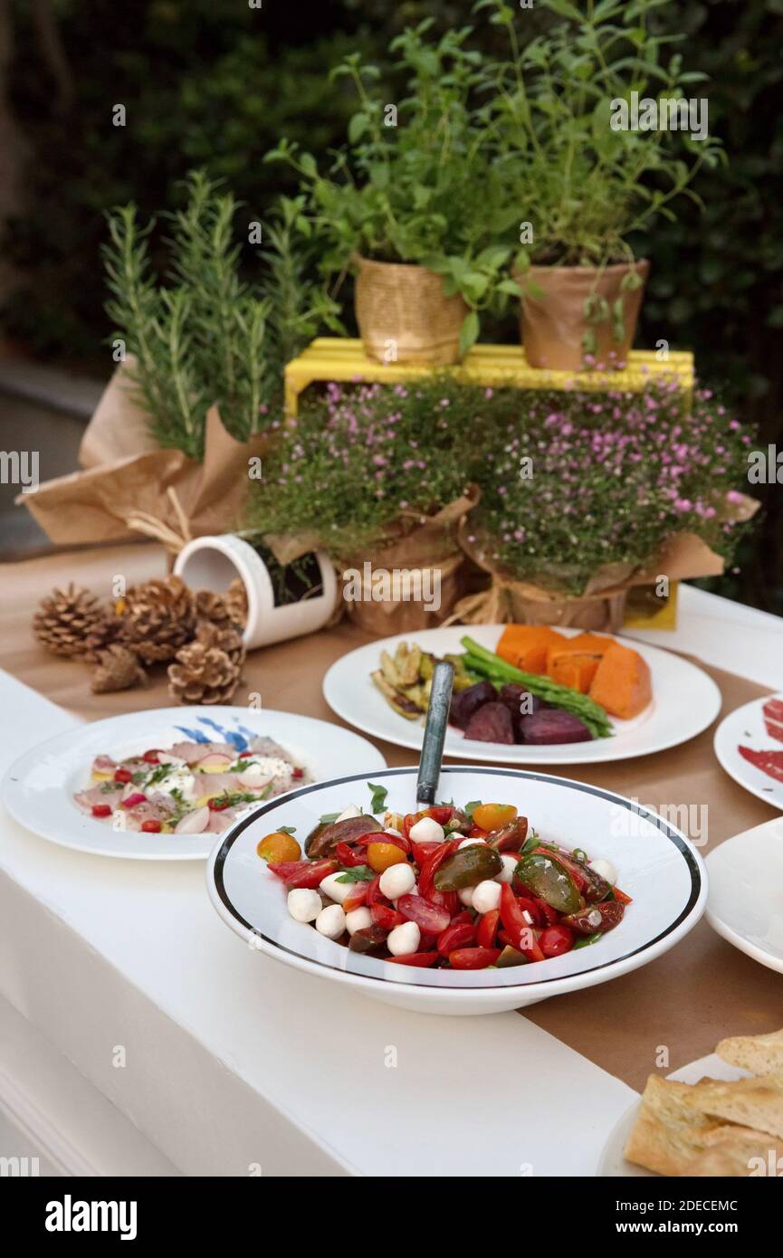 Dinner buffet table laid out with an assortment of food at an evening ...