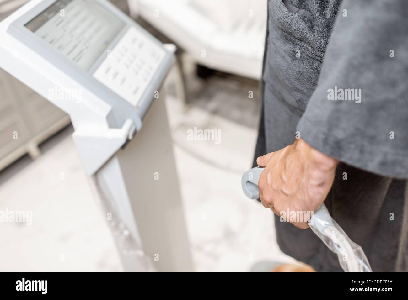 Man measuring body composition balance, holding handles of a medical ...