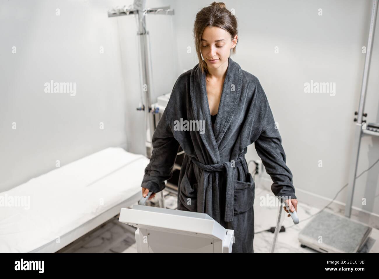 Woman measuring body composition balance, standing on the medical ...