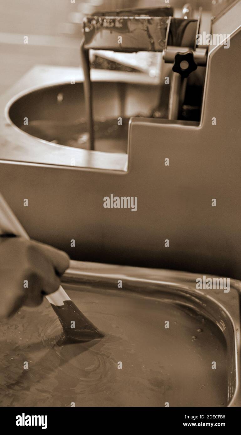 Mixing and blending Dark chocolate by an artisanal chocolatier Stock ...