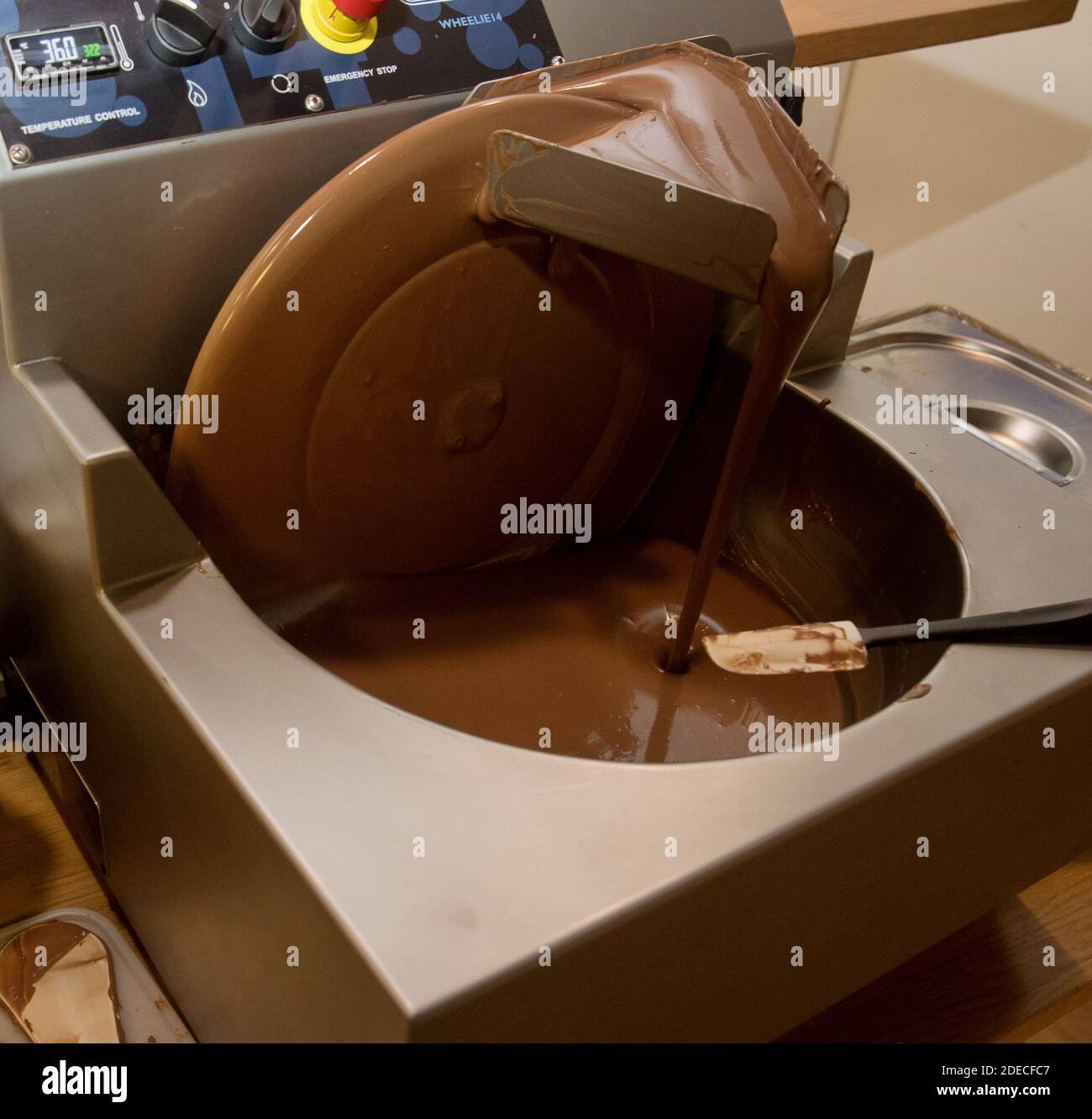 Mixing and blending Dark chocolate by an artisanal chocolatier Stock ...