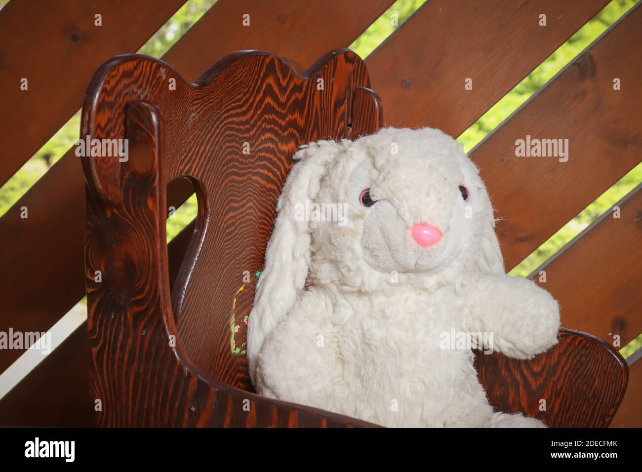 Adorable stuffed toy rabbit sitting in a rocking chair Stock Photo - Alamy